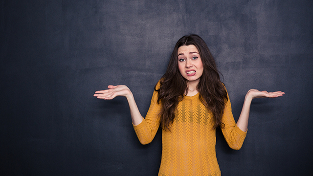 Young woman shrugging shoulders - Mirasee